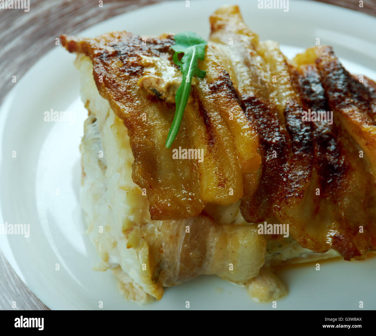 Baked cod wrapped in bacon Stock Photo - Alamy