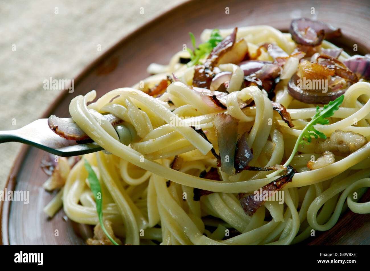 Tagliatelle alla trevisana. Italian pasta with fried bacon and onions ...