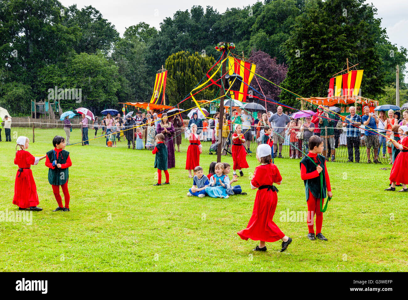 Children In Medieval Costume Maypole Dancing In The Rain During The ...