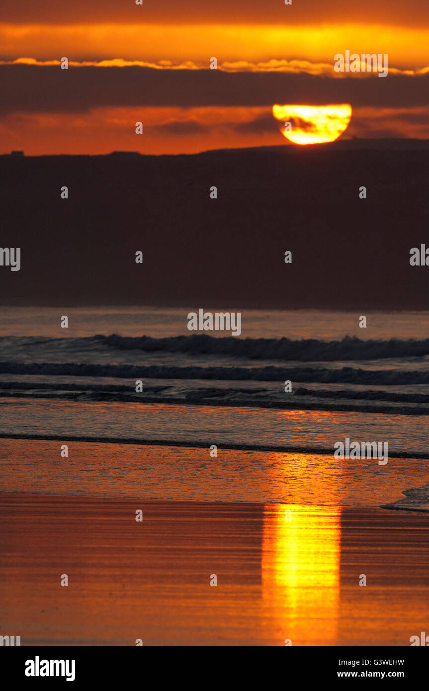 Sunset reflecting off the wet sandy beach Stock Photo - Alamy