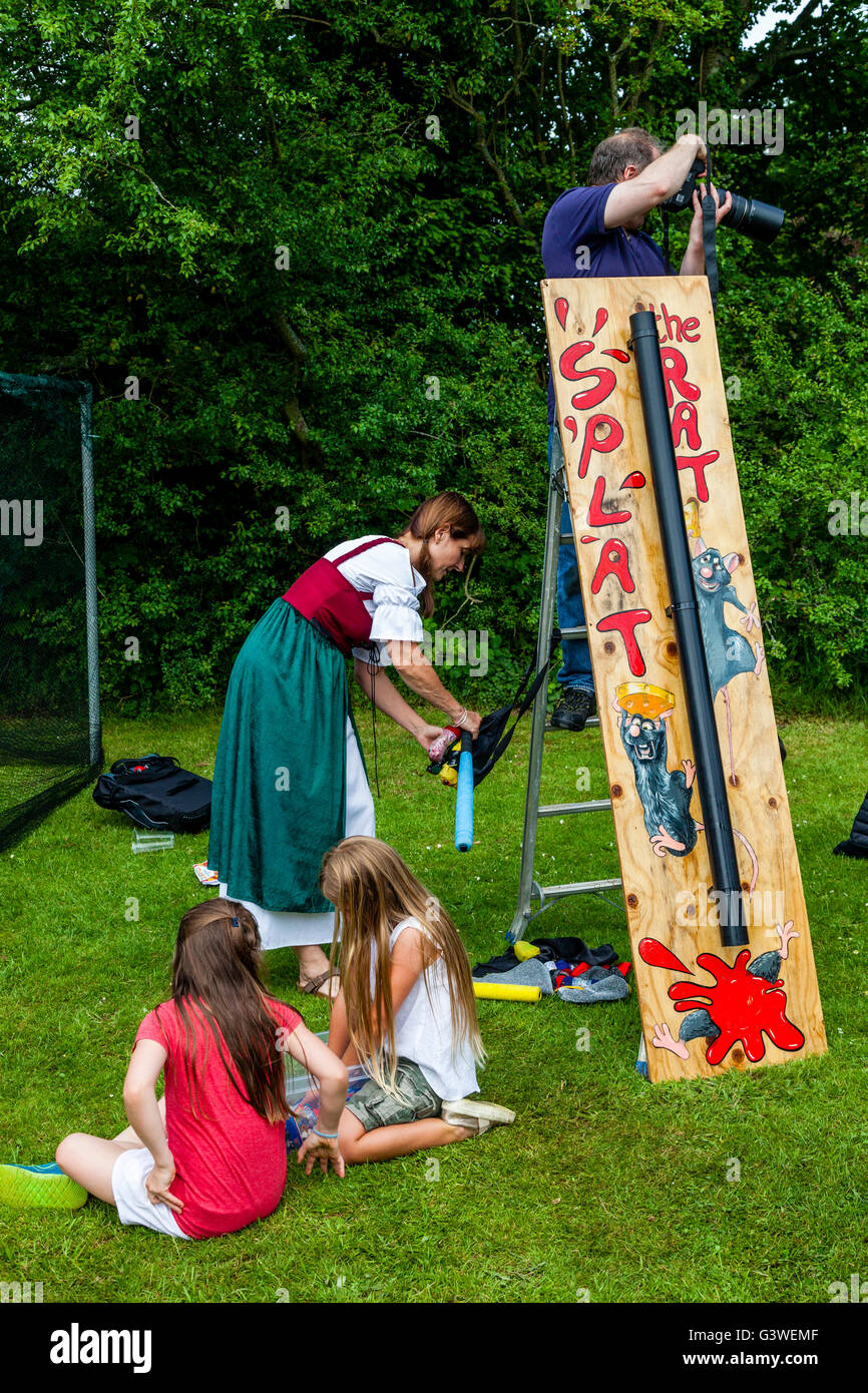 A Woman Sets Up The Traditional Game Of Splat The Rat At The Medieval ...