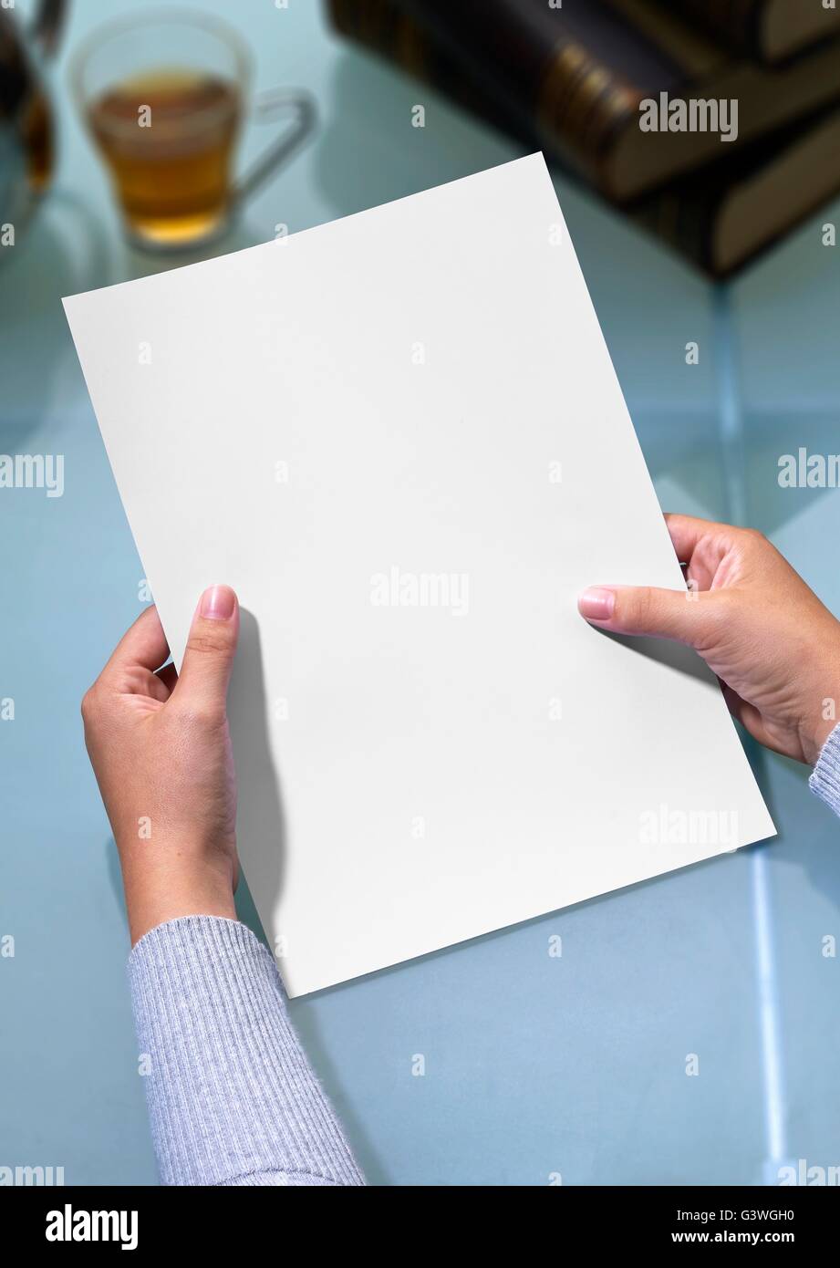 hands holding white paper with clipping path Stock Photo - Alamy
