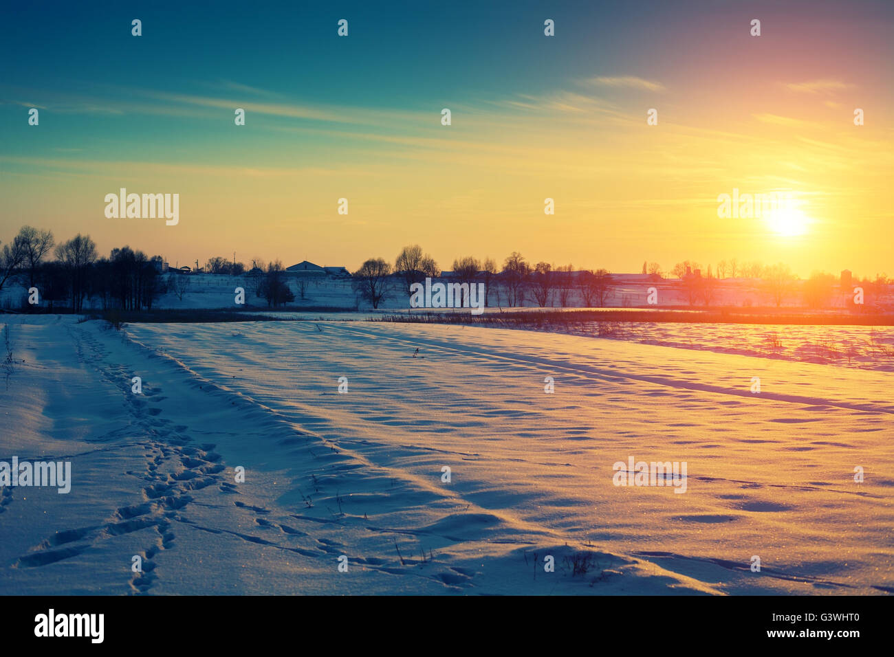 snowy field in winter at sunset Stock Photo - Alamy