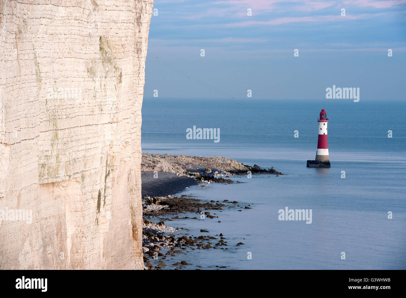 Shear cliff face of Beachy Head and lighthouse in background horizontal ...