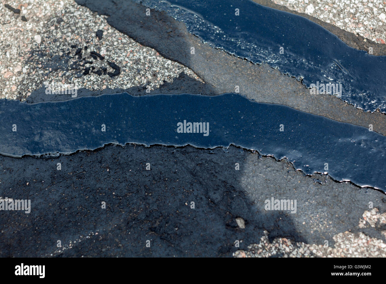 Strips of fresh tar on a weathered asphalt surface Stock Photo - Alamy
