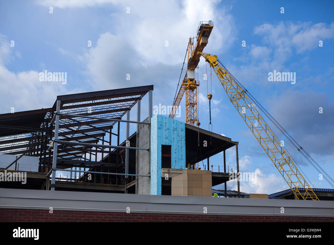 Cranes work above a steel building structure under construction Stock ...