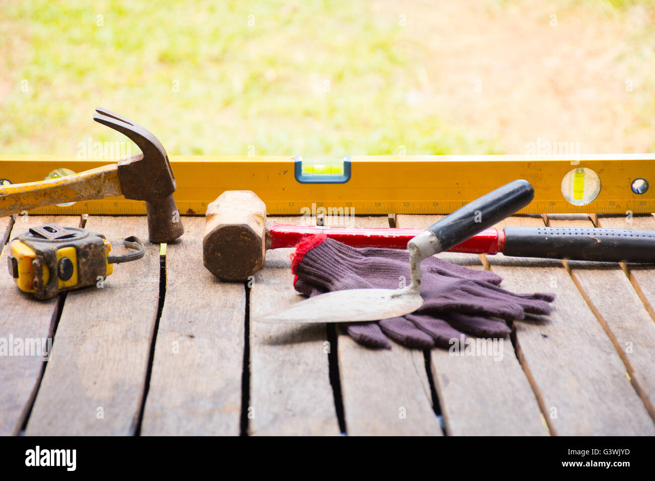 Masonry tool background such as glove and tape measure and sledgehammer ...