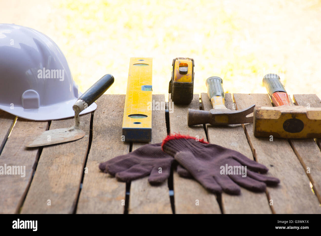 Masonry tool background such as glove and tape measure and sledgehammer ...