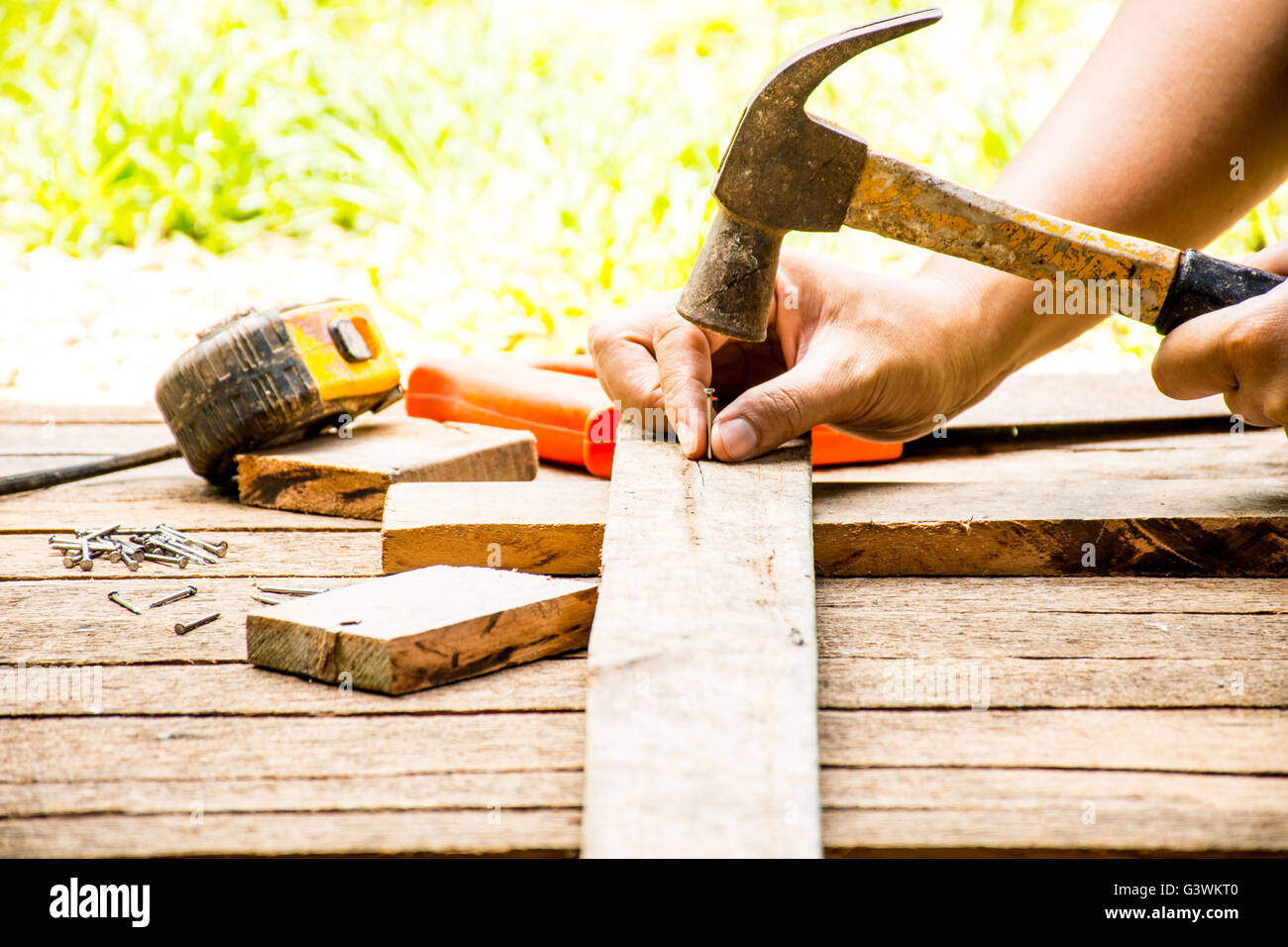 Background Craftsman tool old hammer with tape measure and small nails ...