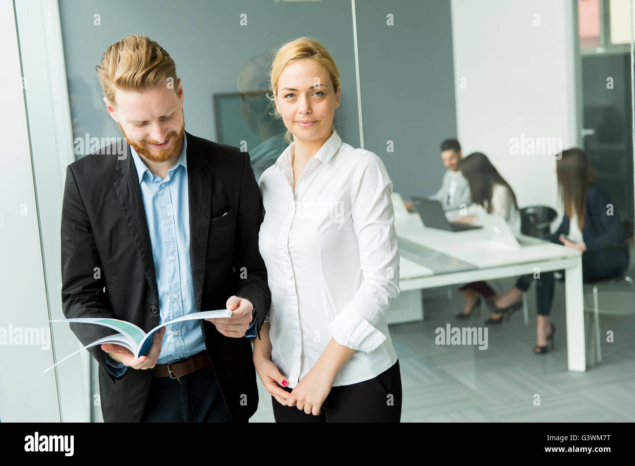 Young business couple working in the office Stock Photo - Alamy