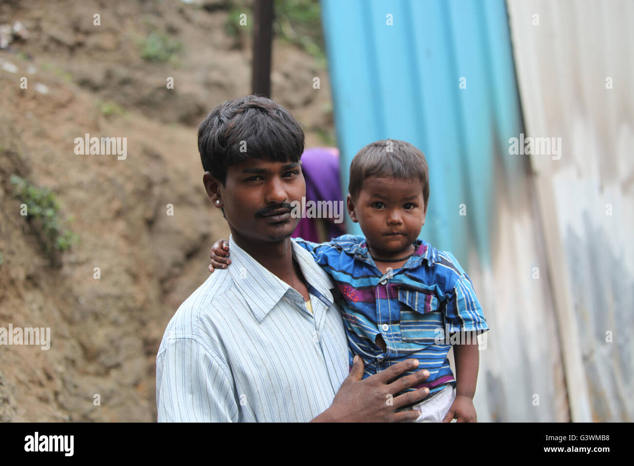 A little boy with his poor father who is a construction worker, in ...