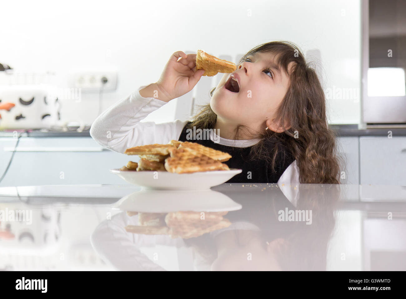 Girl eating waffles Stock Photo - Alamy