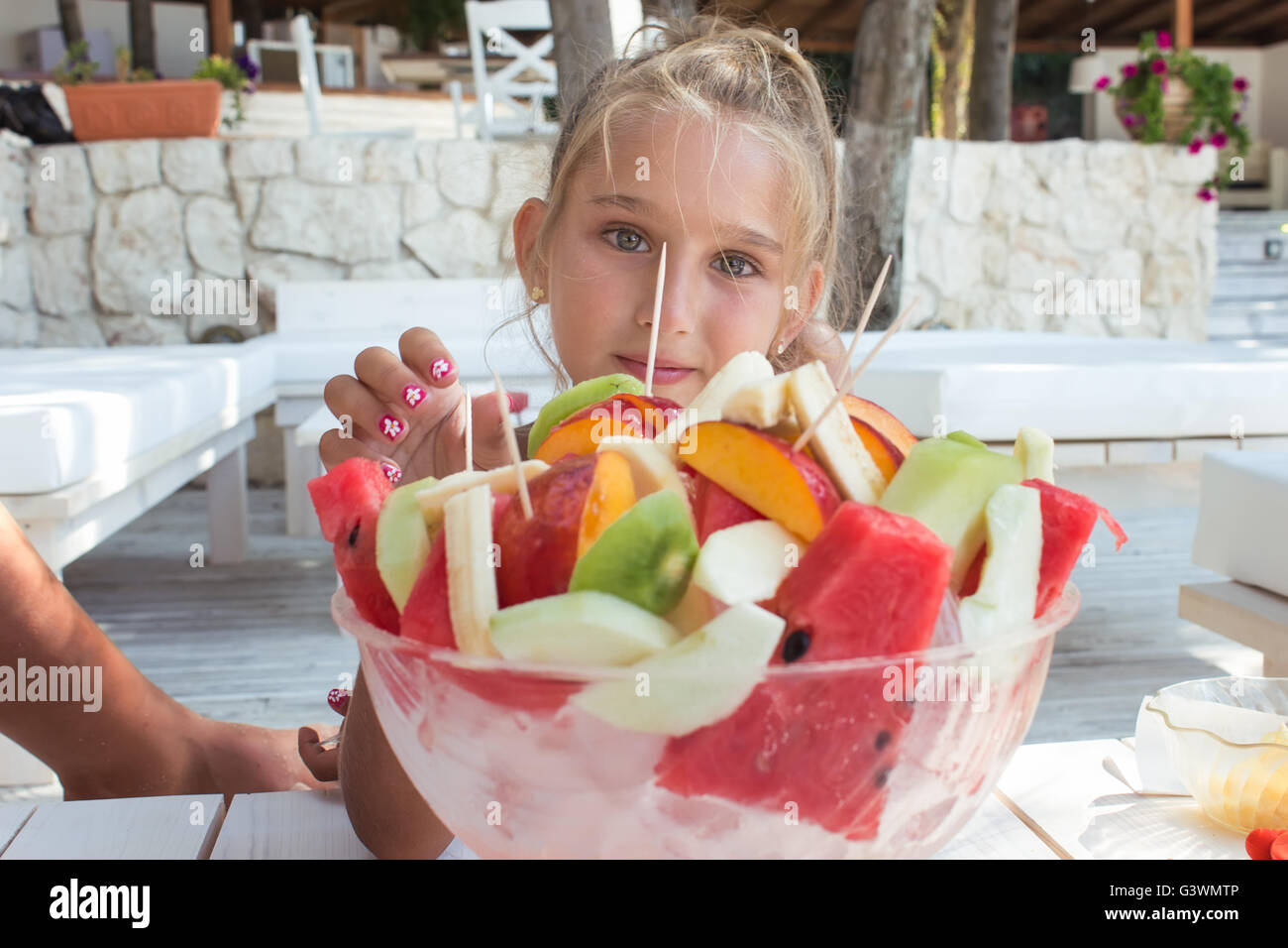 Girl eating fruit salad Stock Photo - Alamy