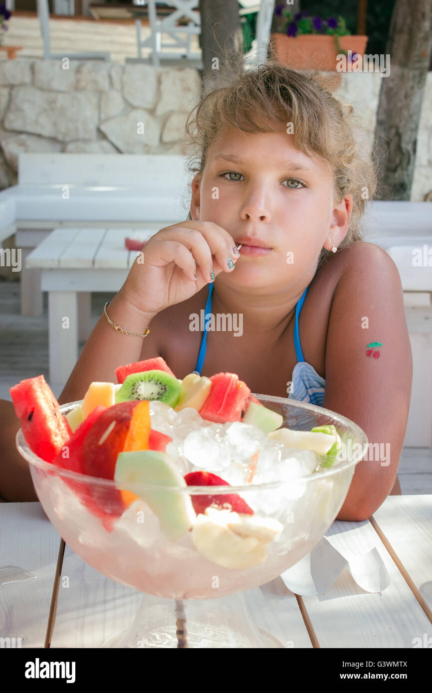 Girl eating fruit salad Stock Photo - Alamy