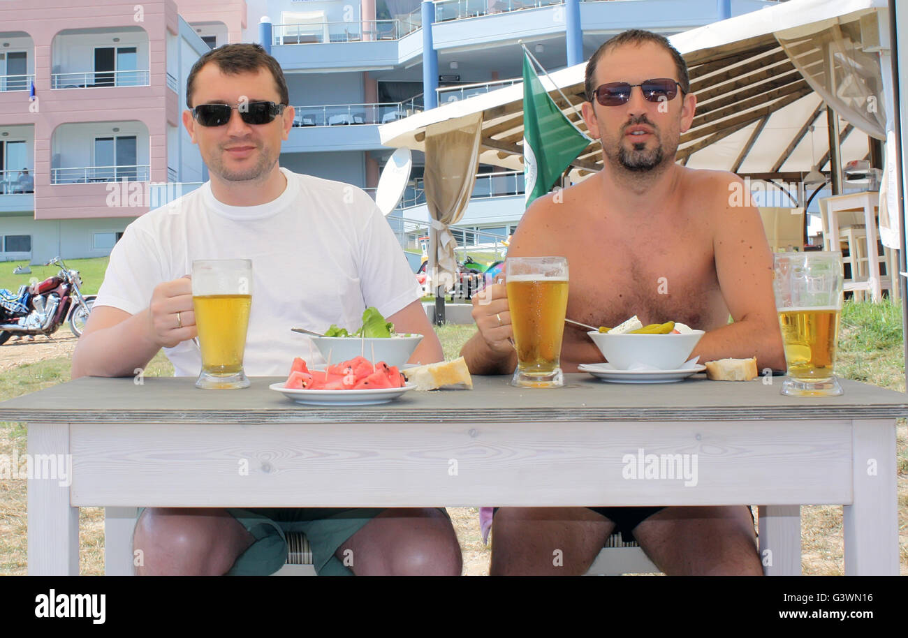 Two men drinking beer Stock Photo - Alamy