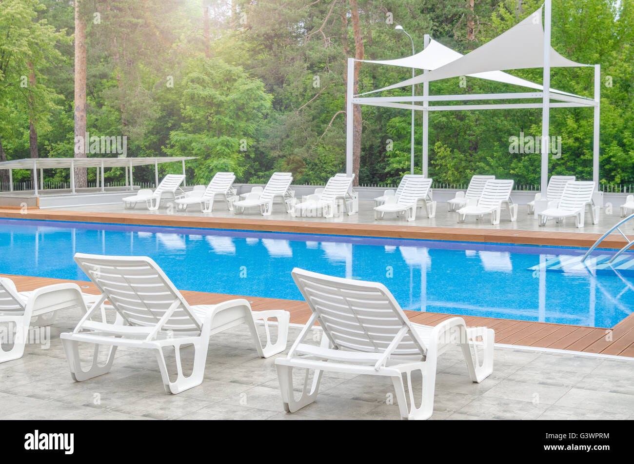 clean swimming pool and empty resting chair Stock Photo - Alamy