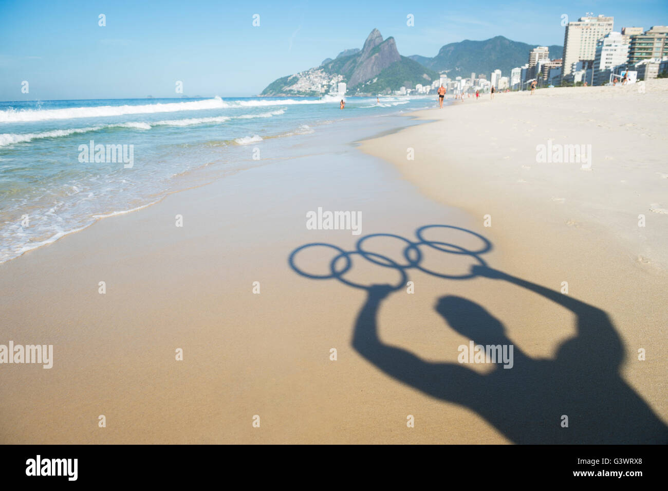 RIO DE JANEIRO - MARCH 20, 2016: Shadow of man holding Olympic rings on ...