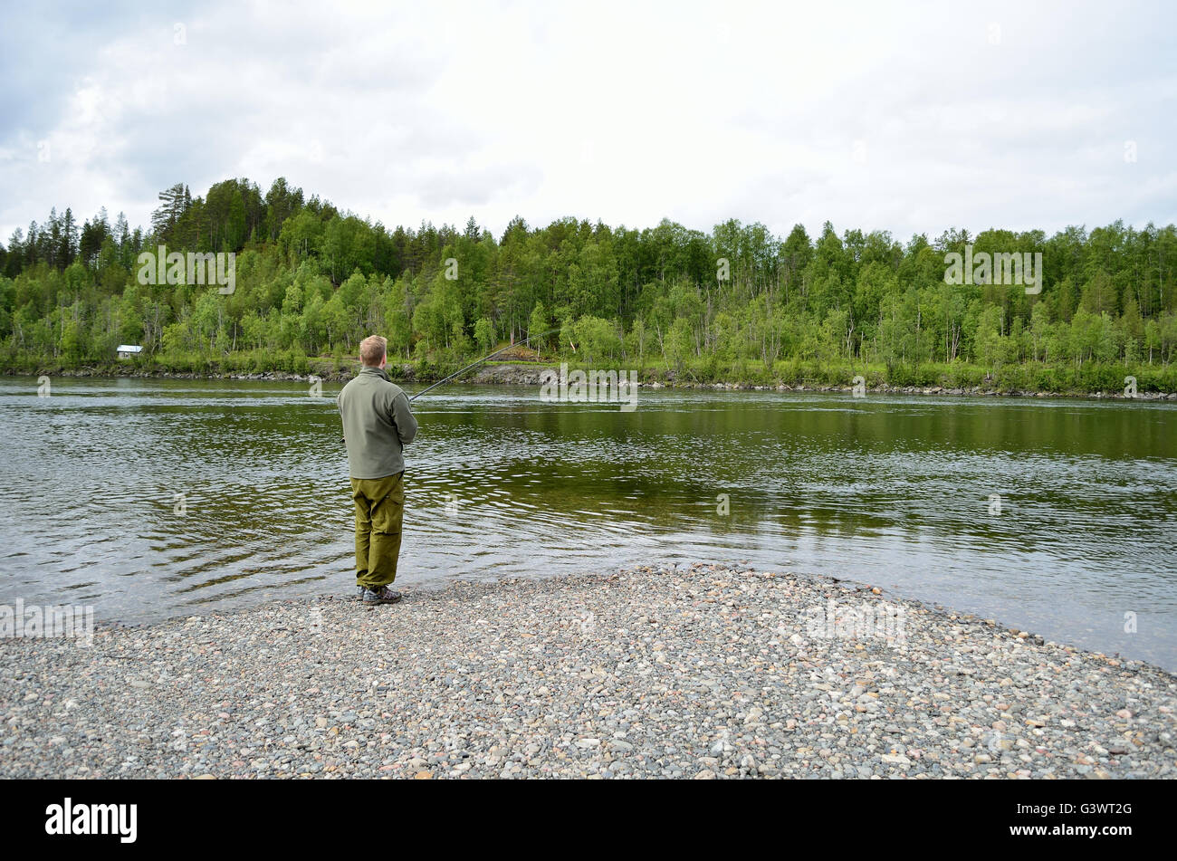 Young man reeling in fishing hi-res stock photography and images - Alamy