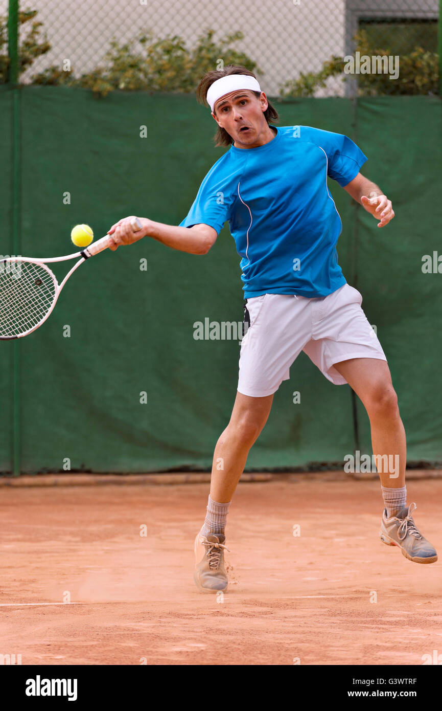 Young man playing tennis Stock Photo - Alamy