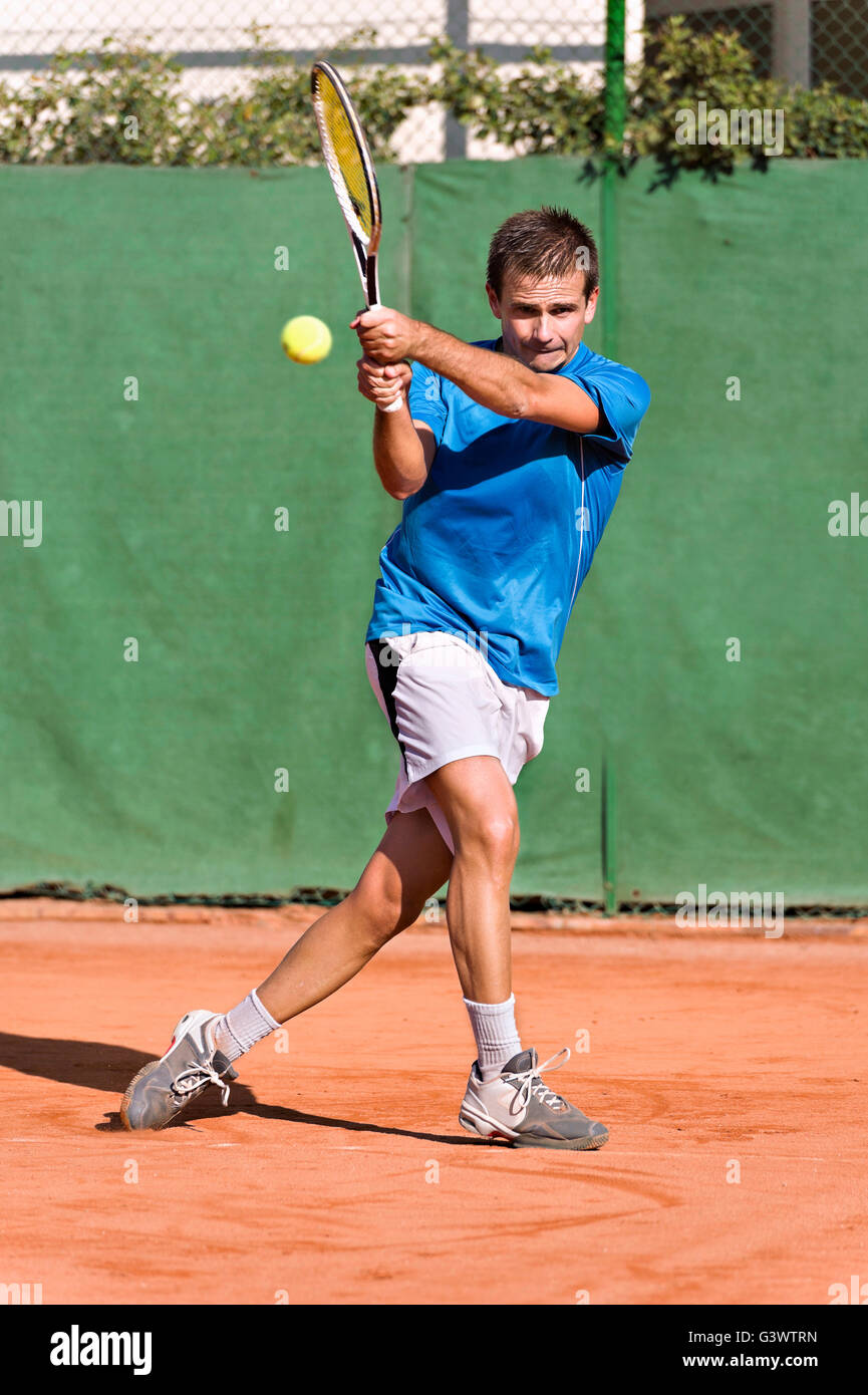 Young man playing tennis Stock Photo - Alamy
