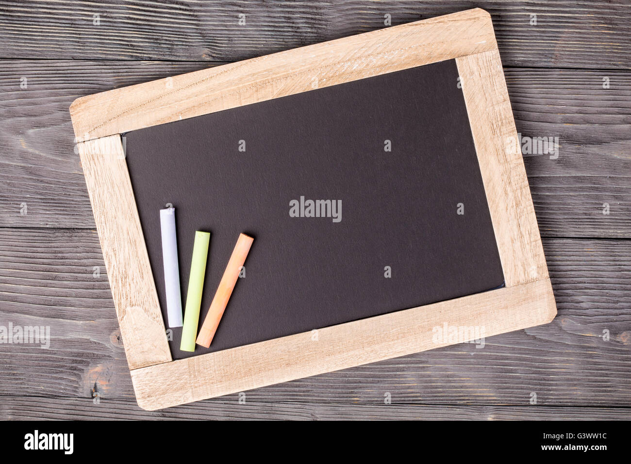 Blackboard and chalks with black copy space Stock Photo - Alamy