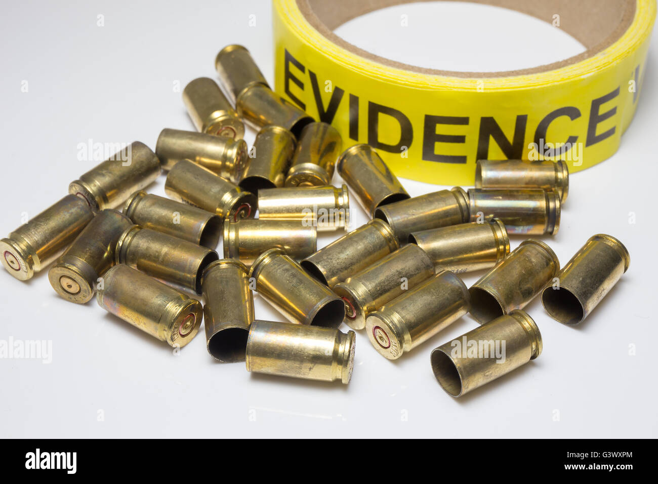 evidence tape with brass bullet cases on white background Stock Photo ...