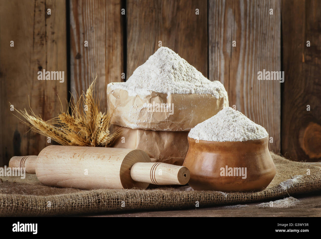 Natural, organic, wholegrain wheat meal in a paper bag, a rolling pin ...