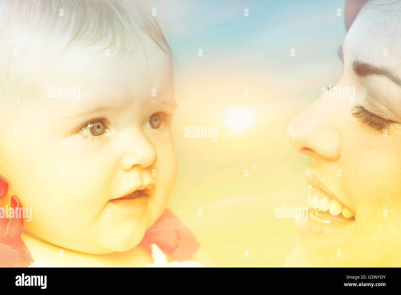 portrait of mother and her baby in front of sunset Stock Photo - Alamy