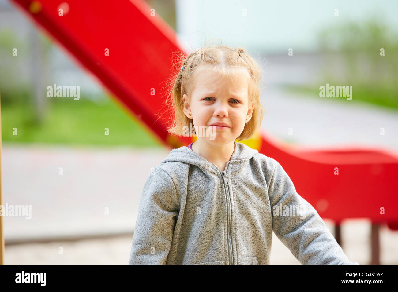Beautiful sad little girl crying, on summer background Stock Photo - Alamy