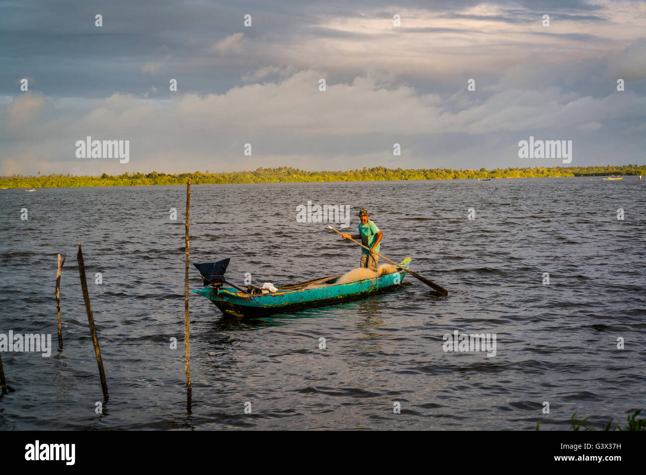 Fisherman in fishing boat on the lake, Marechal Deodoro, Maceio ...