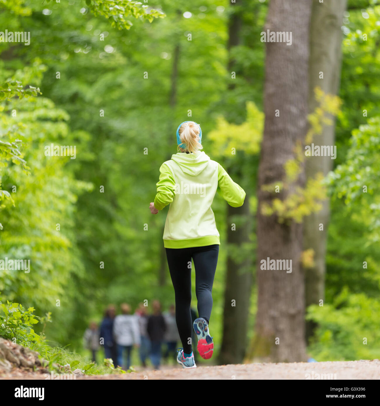 Sporty young female runner in the forest Stock Photo - Alamy