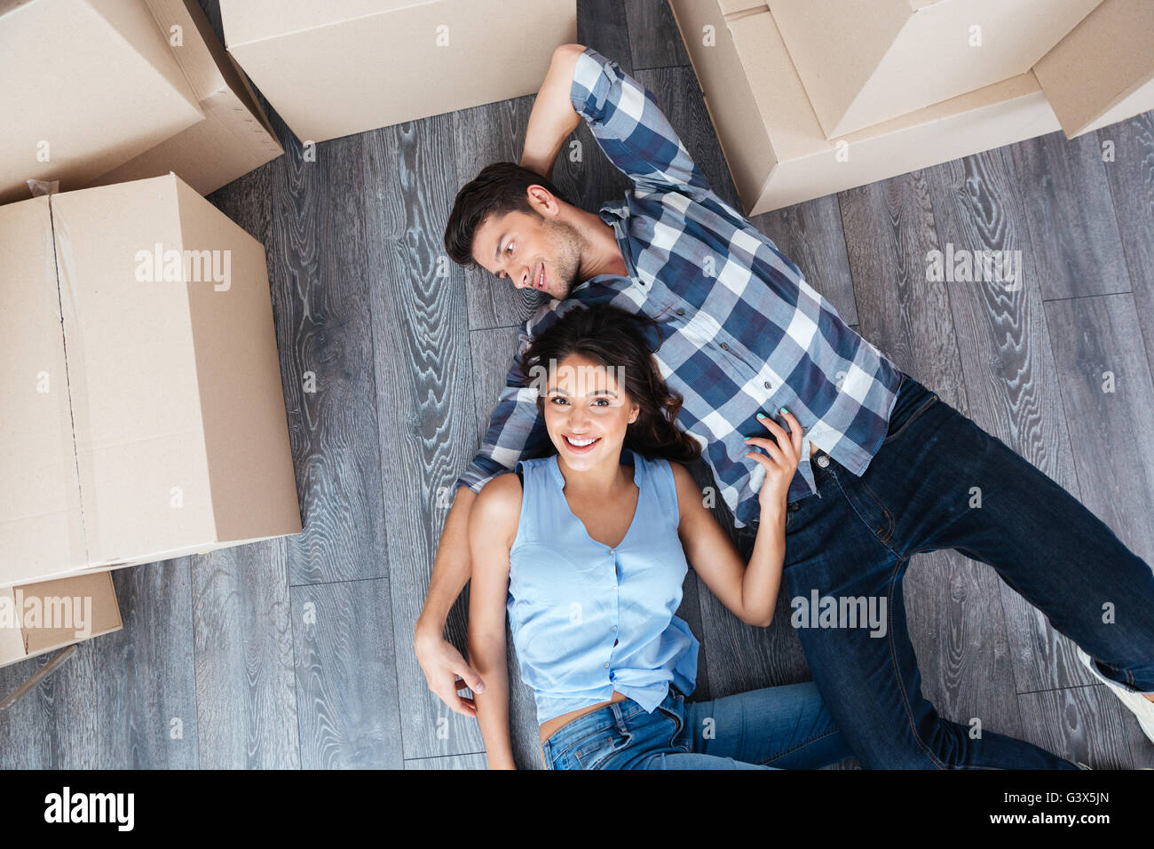 Portrait of young smiling happy couple moving in new home Stock Photo ...
