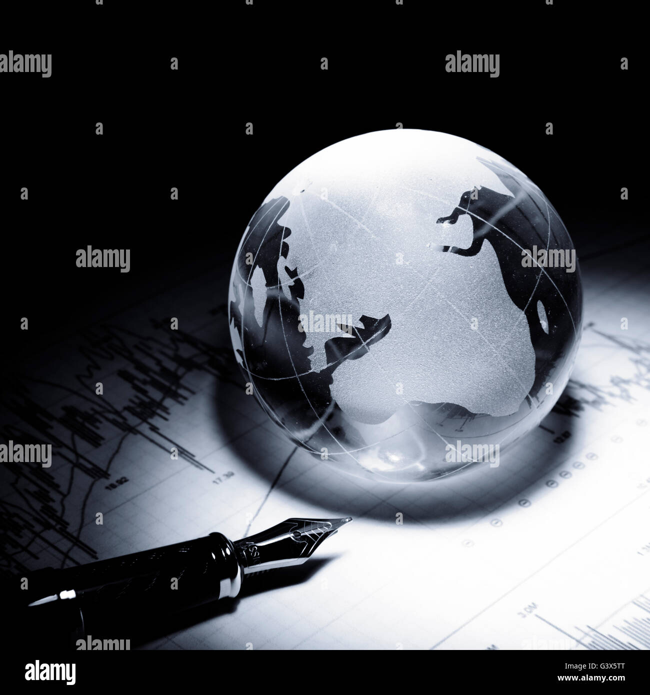 business concept of a glass globe on a trading chart with pen Stock ...