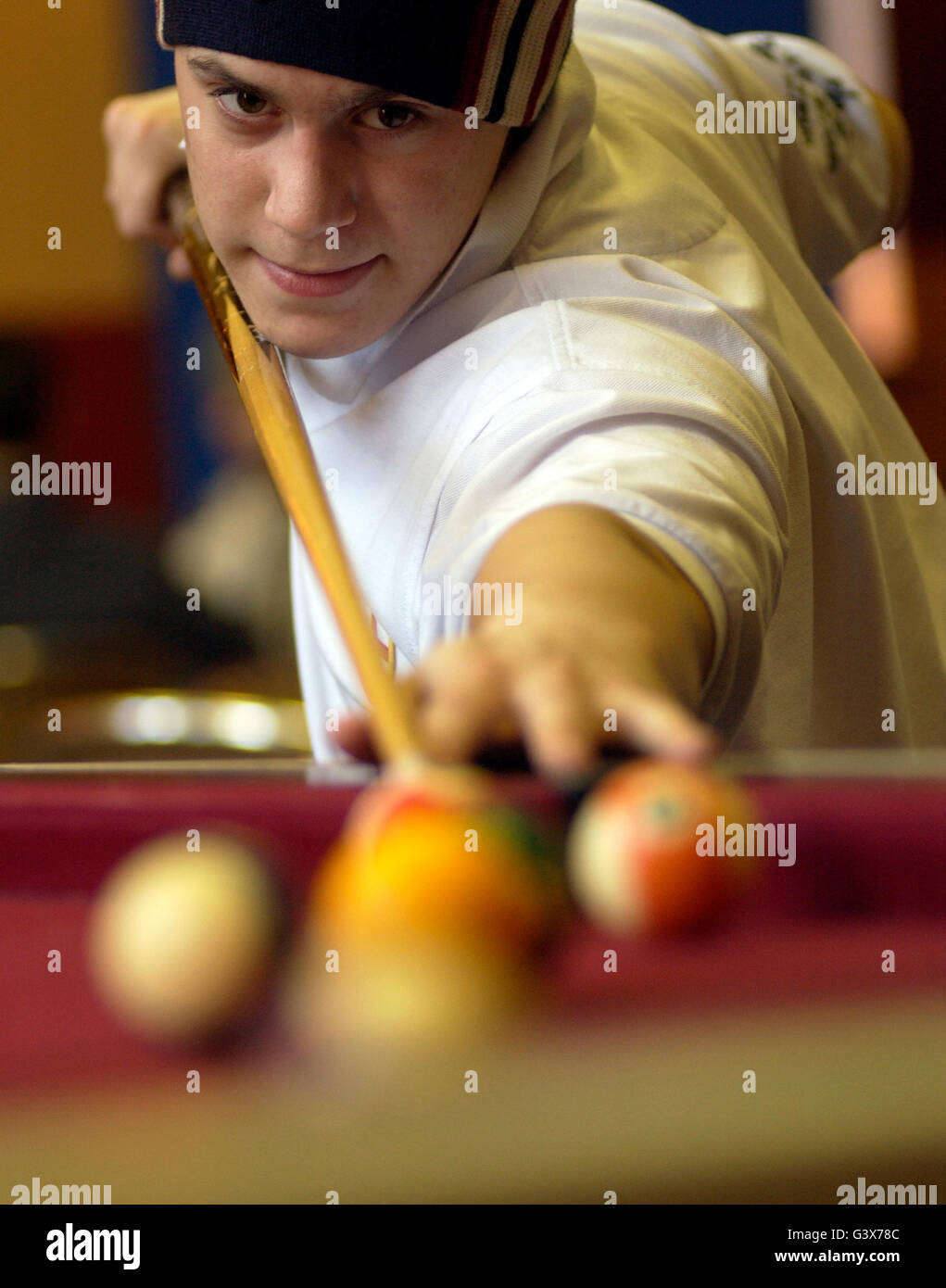 Student playing pool at youth centre Stock Photo - Alamy