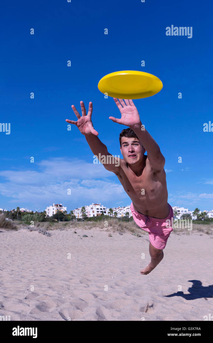 Boy Dives to Catch Frisbee. Boy is launched to capture the frisbee on ...