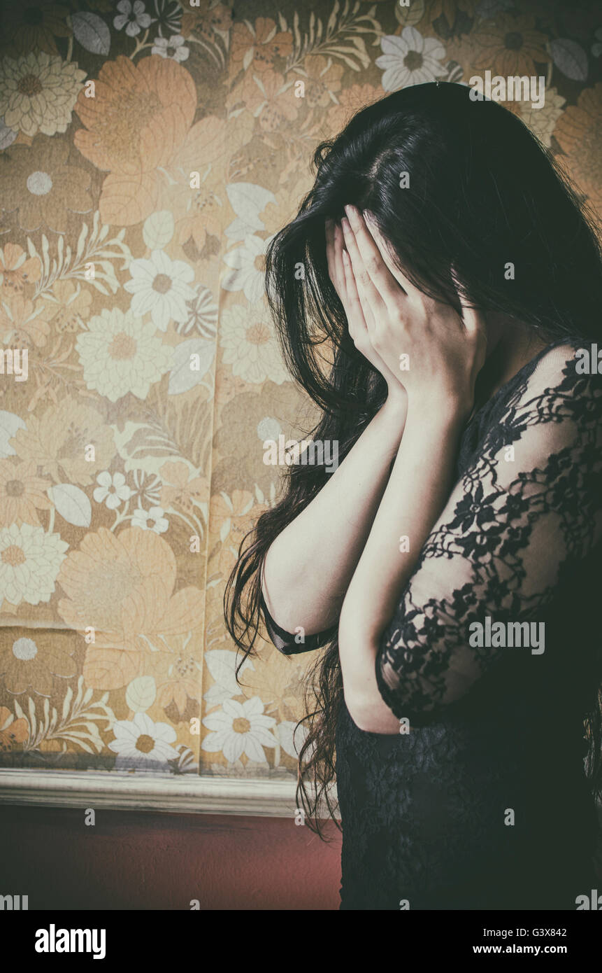 Woman hiding face in hands crying Stock Photo - Alamy
