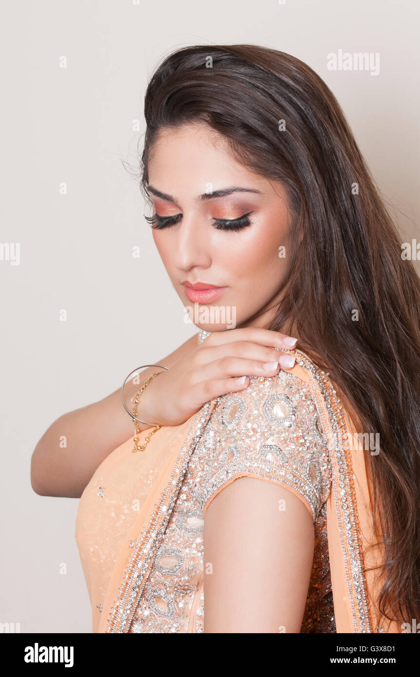 Beautiful Indian woman hand touching shoulder Stock Photo - Alamy