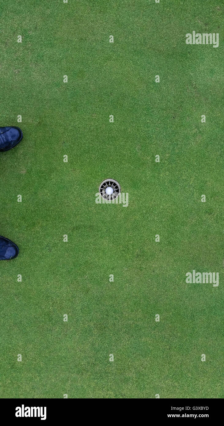 a view of a beautiful golf course and a hole Stock Photo - Alamy