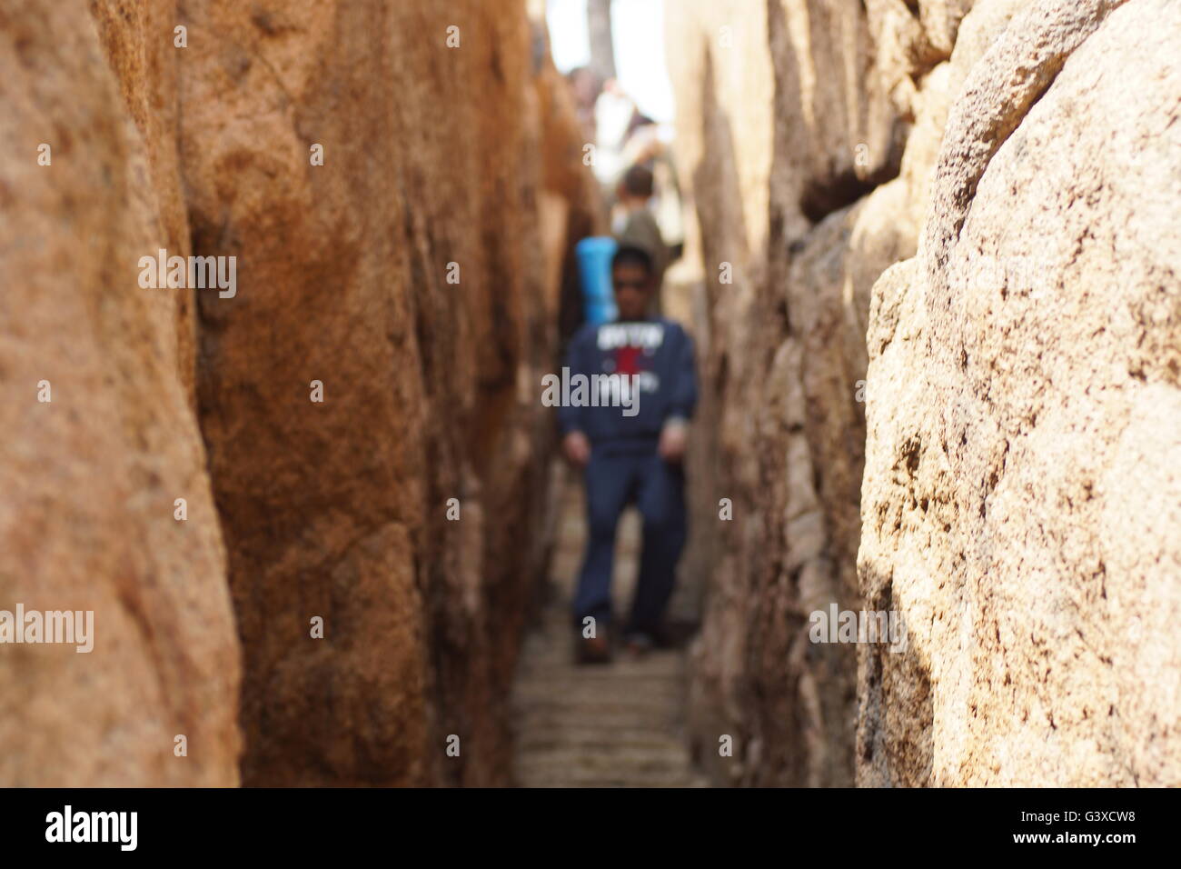 A narrow path between walls in the mountains. Qianshan National Park ...