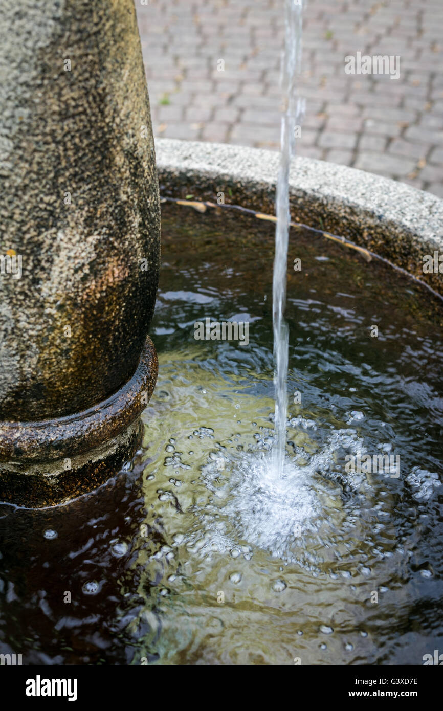 Splashed water drops in a stone standpipe Stock Photo - Alamy