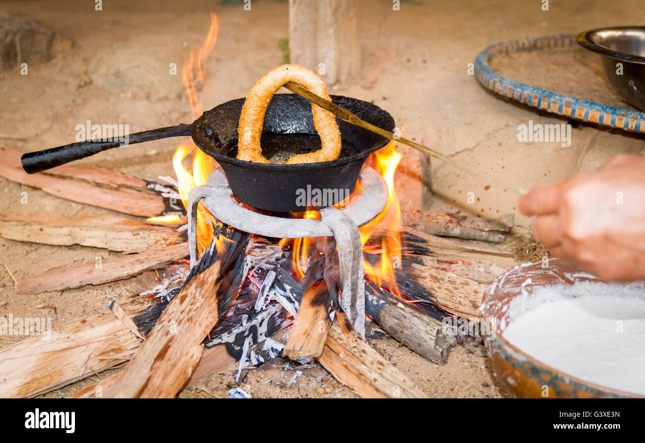 cooking Sel Roti or Nepali style bread for the wedding ceremony in the ...