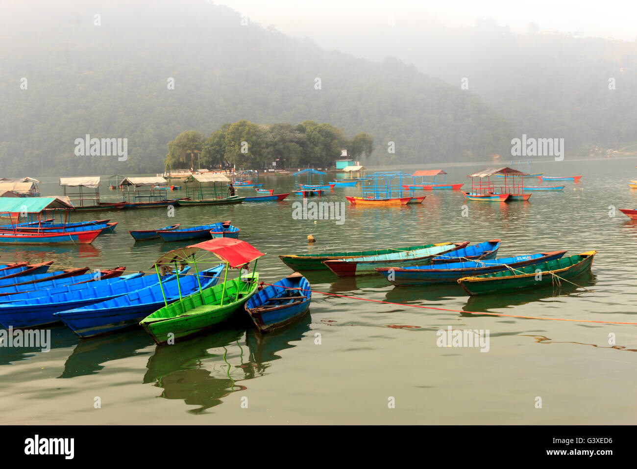View of Phewa lake with colourful boats on the water in Pokhara,Nepal ...