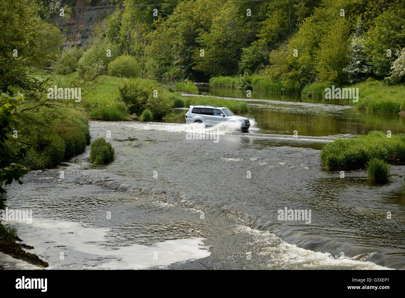 Vehicle fording a minor road over the River Whiteadder in the Scottish ...