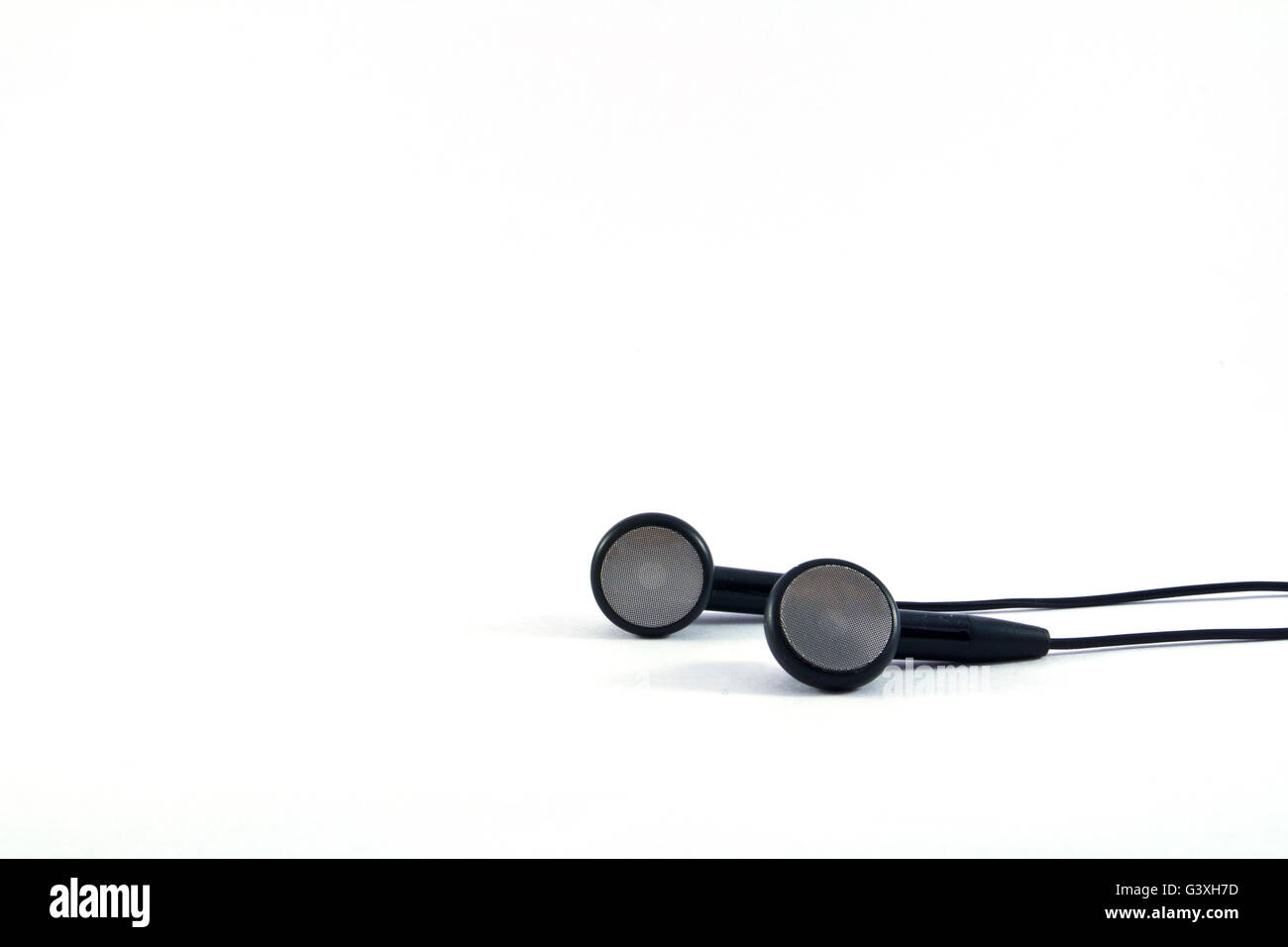 Black headphones with wires on white background Stock Photo - Alamy