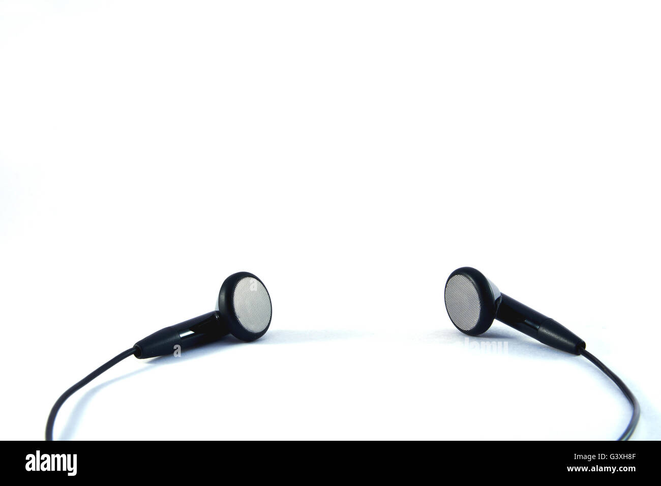 Black headphones with wires on white background Stock Photo - Alamy