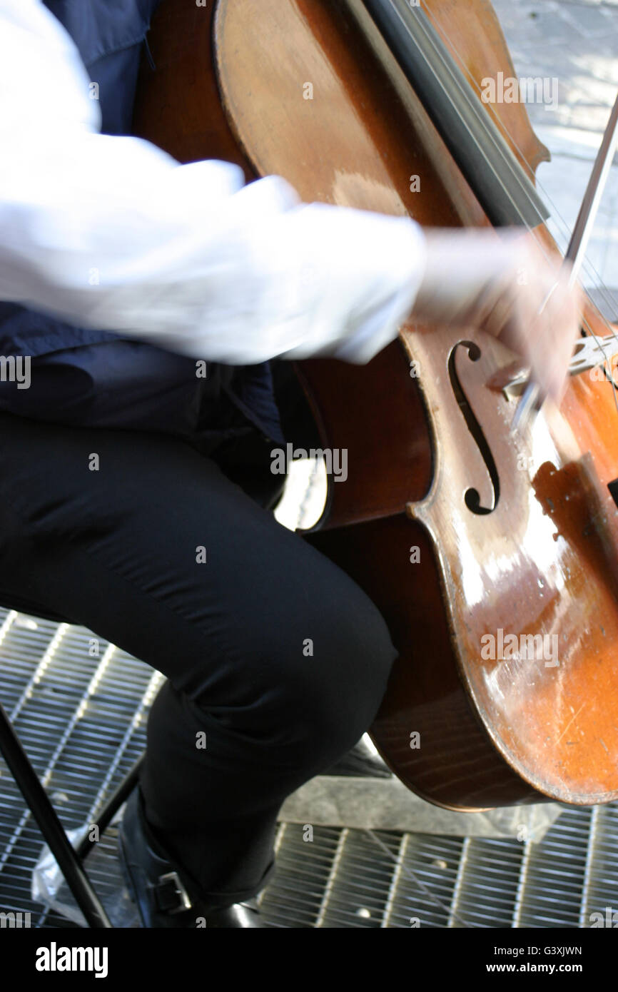 a detail of a musician playing the contrabass with fiddle, musical ...
