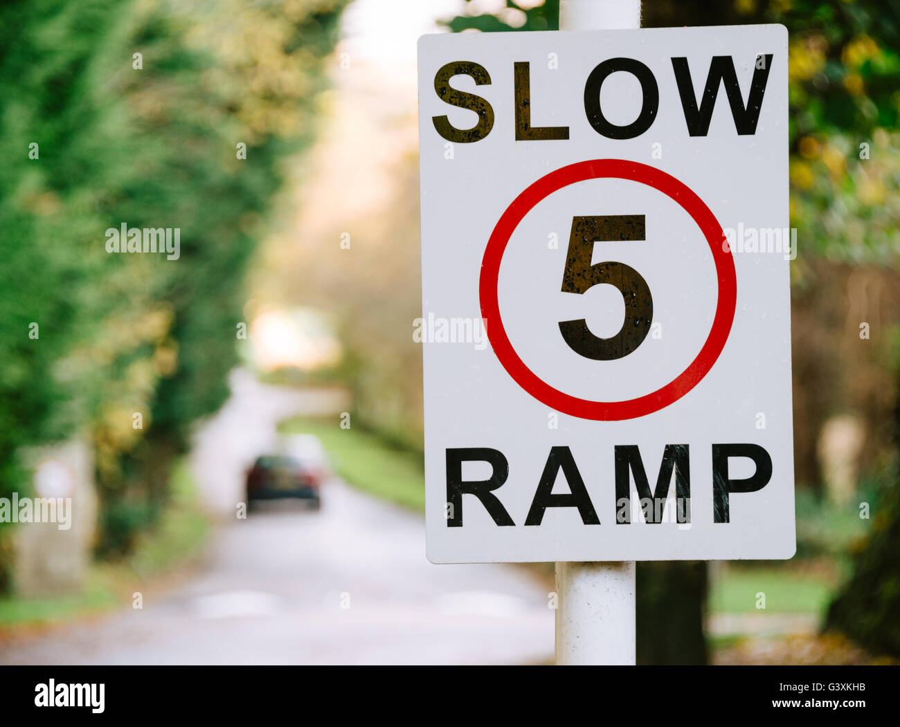 Slow ramp five sign with blurred car in distance Stock Photo - Alamy