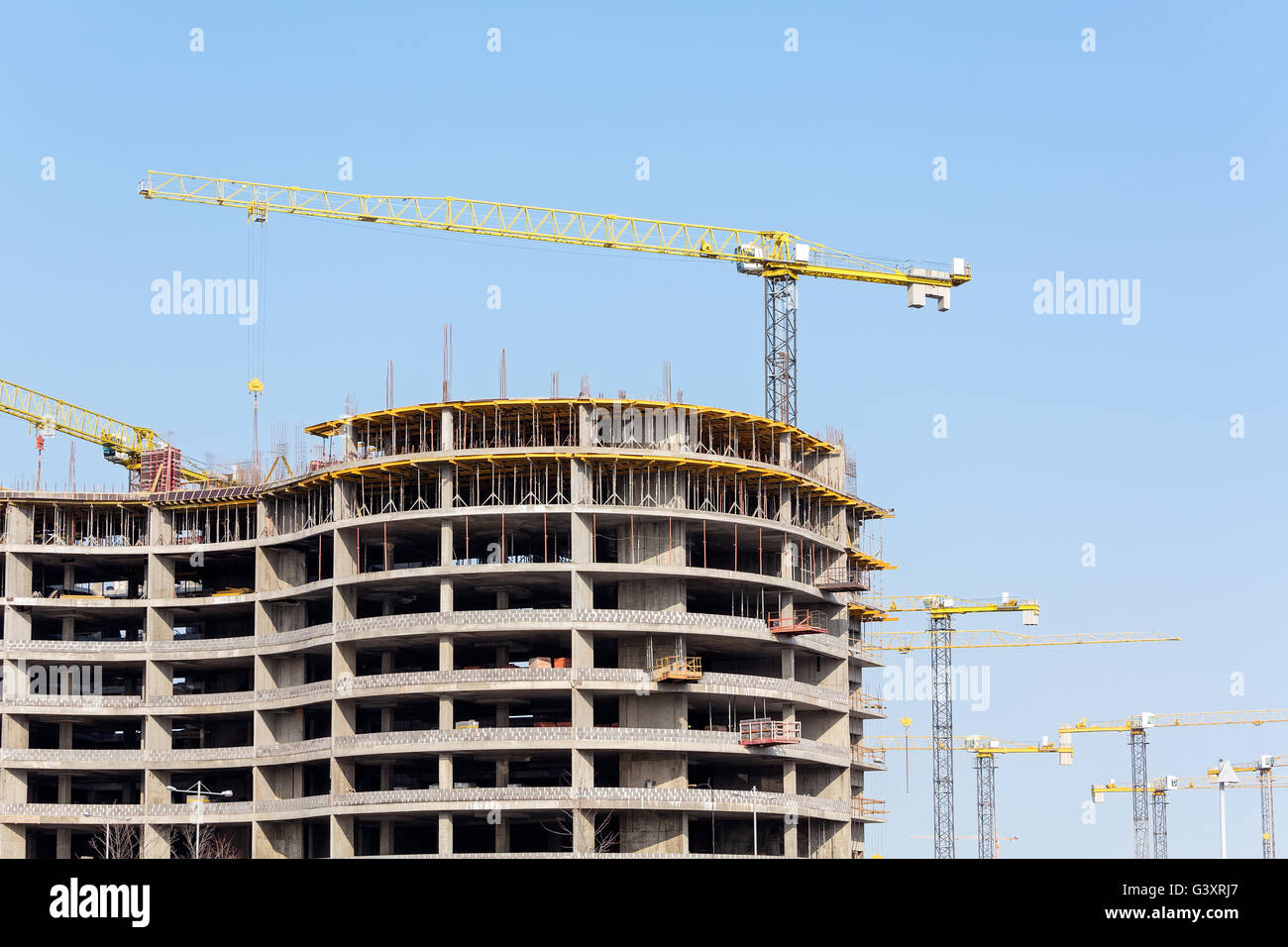 Multiple building cranes working on huge construction site Stock Photo ...