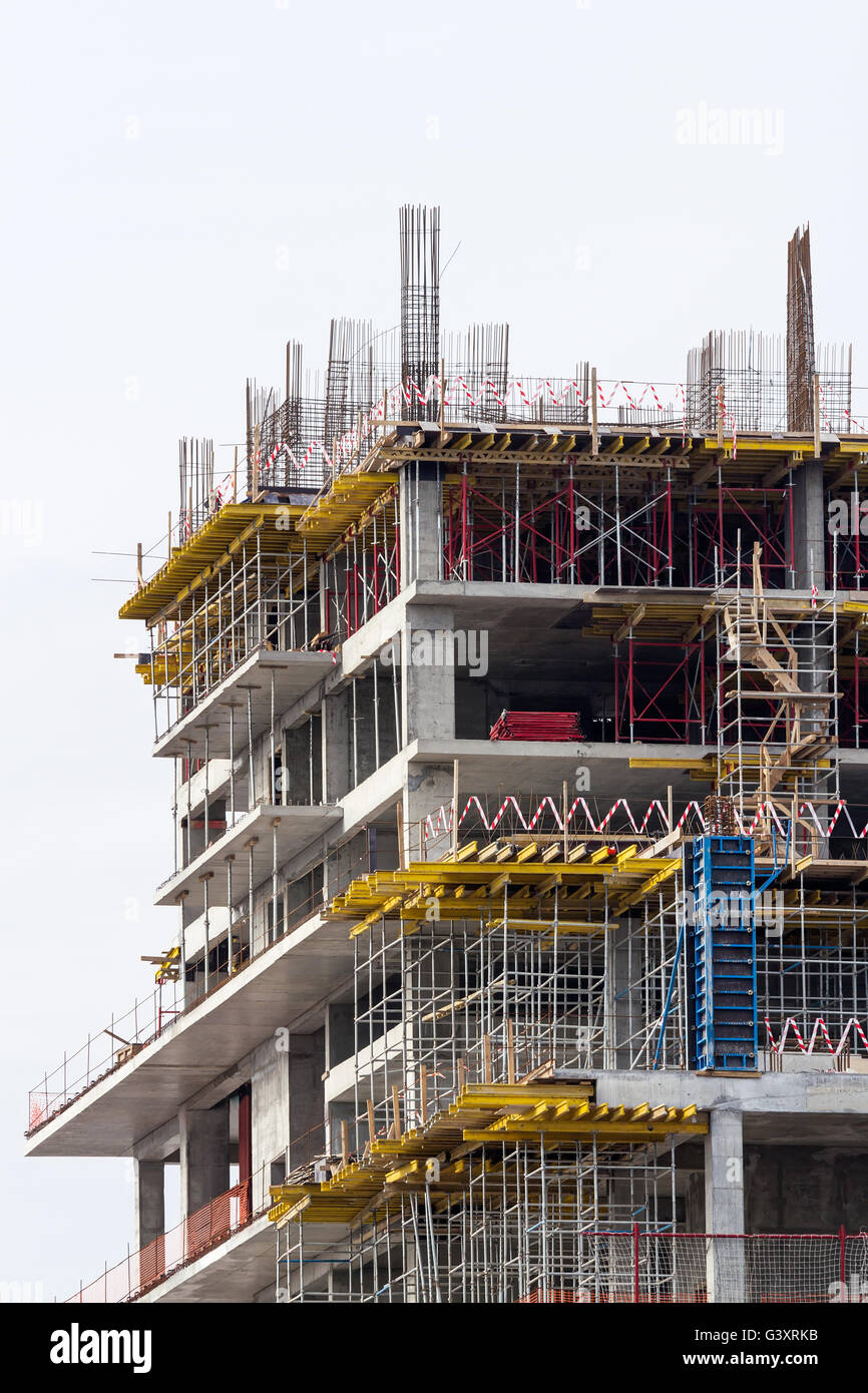 High rise building under construction with scaffolding Stock Photo - Alamy