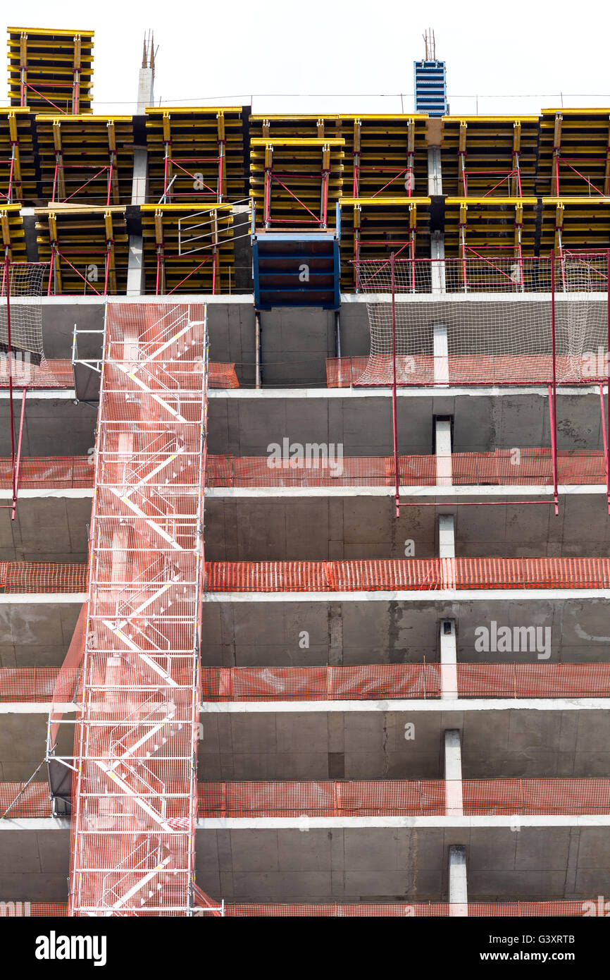 Building facade under construction with red protective mesh Stock Photo ...
